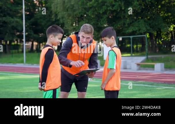 Front view of confident experienced young football coach which ...