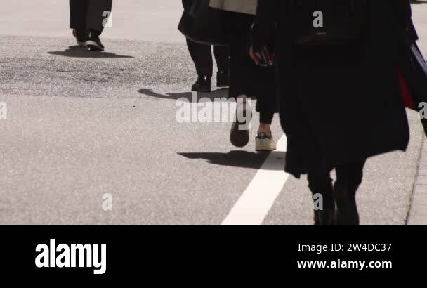 A slow motion of body parts of walking people at urban city in Tokyo ...