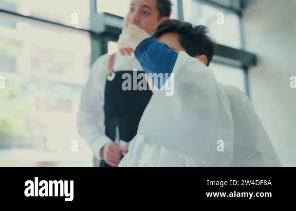 Switching focus between the barber and the customer. Slow motion camera ...
