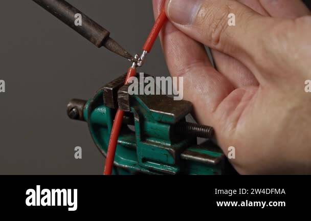 Soldering two red wires with flux and smoke Stock Video Footage - Alamy
