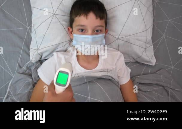 A recovering boy with normal temperature that is shown on a display of ...
