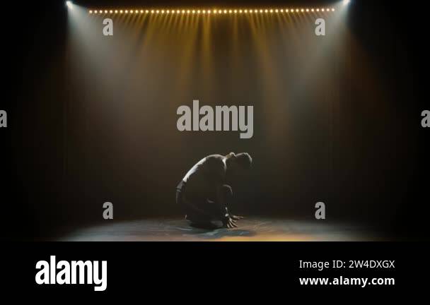 Young handsome guy in tracksuit vigorously dancing break dance ...