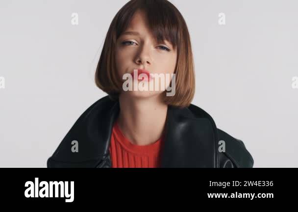 Sad brunette girl has disappointed look posing on camera over white ...