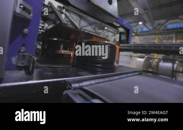 Packing reels with cable on a modern conveyor, automatic packing reels ...