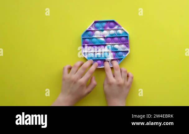 Popit antistress toy for children entertainment on a yellow background ...