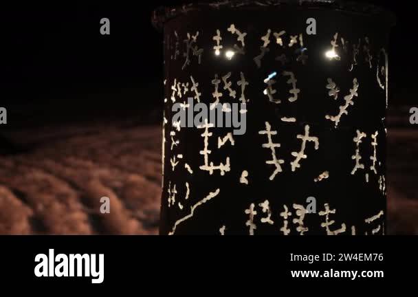Black barrel that glows with ancient viking rune symbols on a winter ...