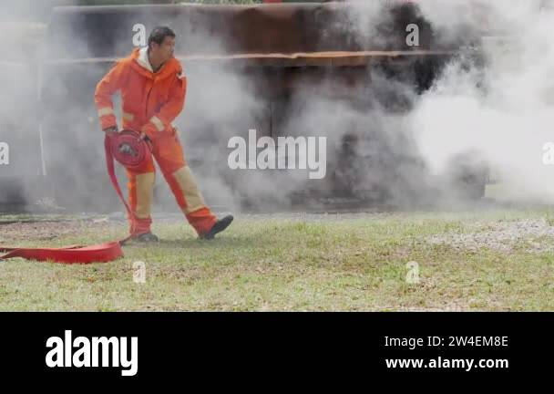 Firefighter fighting with fire flame protection property. Fireman wear ...