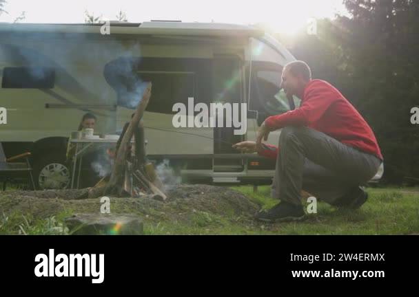 RV Park Campfire and Couple Hanging Together in Front of Their Modern ...
