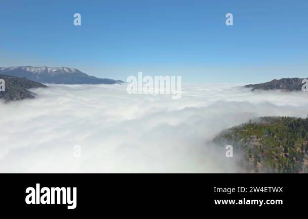 Unique aerial video shows a white ocean of clouds and hilltops covered ...
