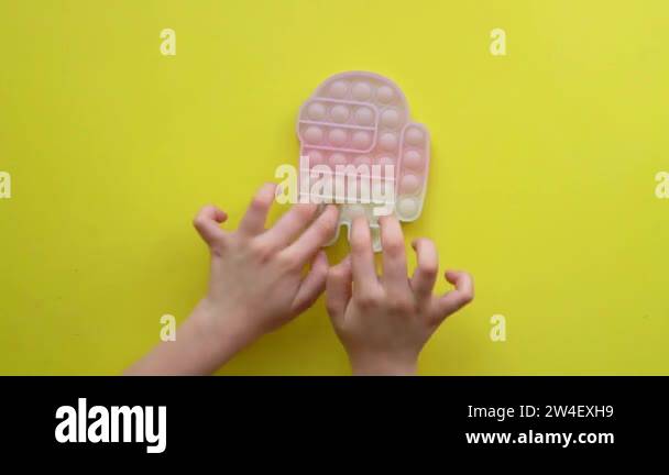 Popit antistress toy for children entertainment on a yellow background ...