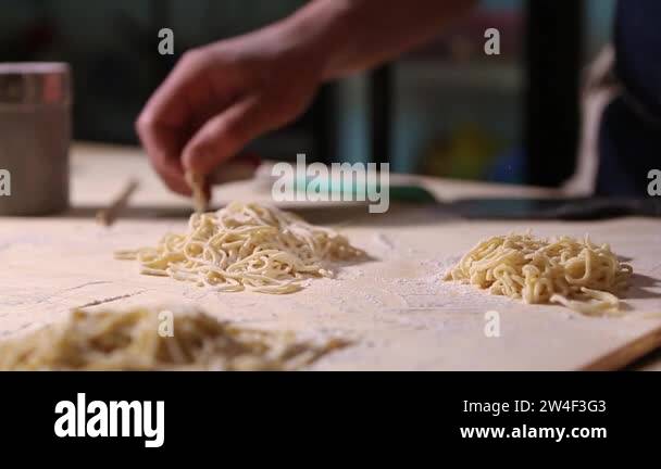 Chef cook makes traditional Italian pasta in restuarant kitchen,filmed ...