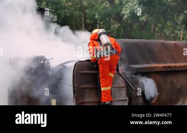 Firefighter fighting with fire flame protection property. Fireman wear ...
