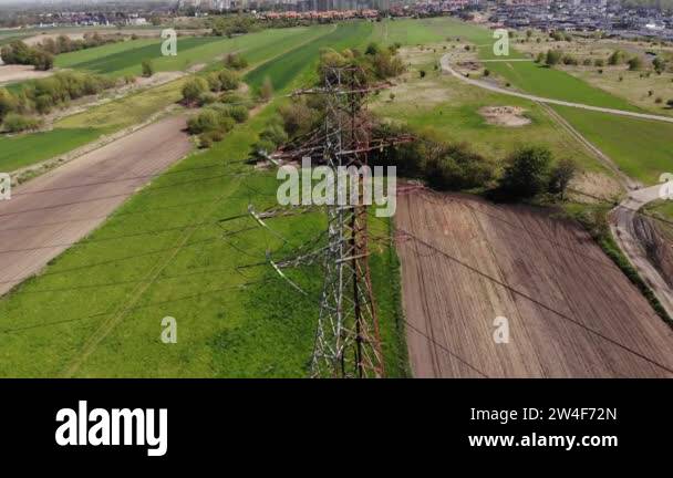 Power pylons and high voltage lines in an agricultural landscape. High ...