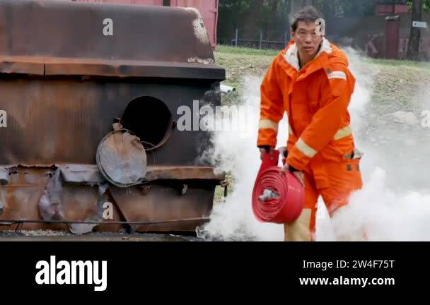 Firefighter fighting with fire flame protection property. Fireman wear ...