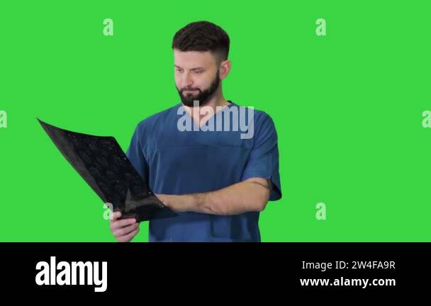 Surgeon studying mri brain scan while walking on a Green Screen, Chroma ...