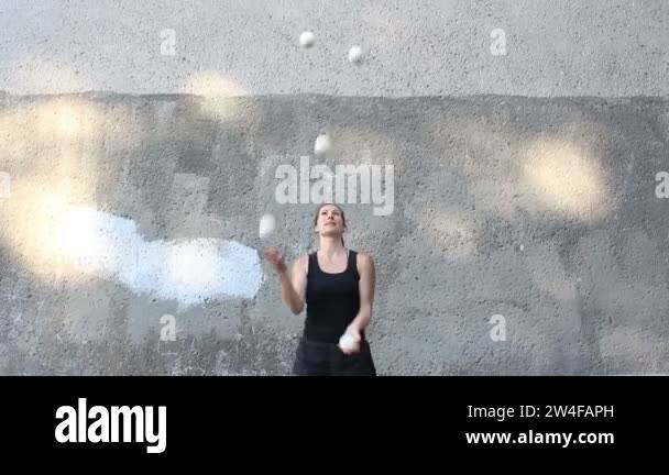 A professional juggler juggles with white balls. A professional circus ...