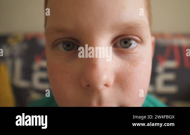 Portrait of little despairing red-haired boy with freckles looking into ...