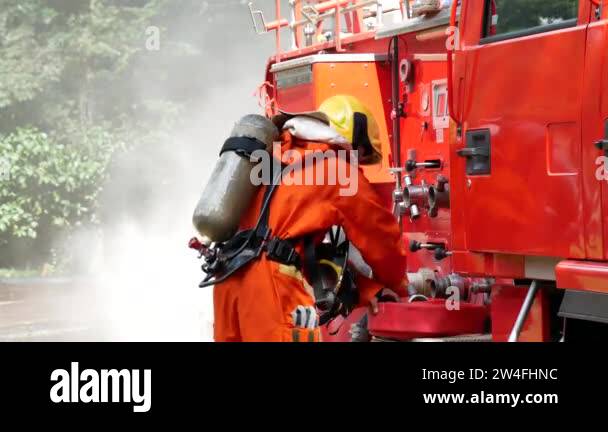 Firefighter fighting with fire flame protection property. Fireman wear ...