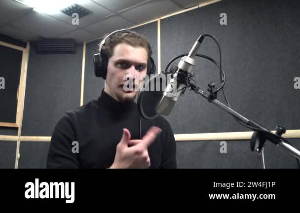 Voice actor in headphones on recording studio ask director way to play ...