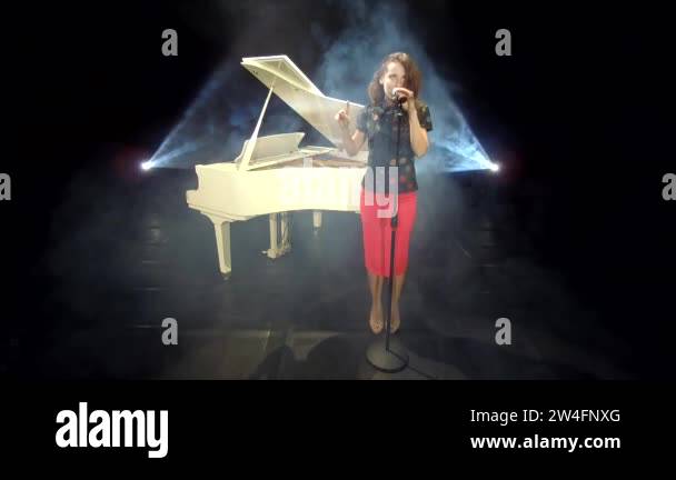 retro lady singer singing jazz in microphone on stage with spotlights ...