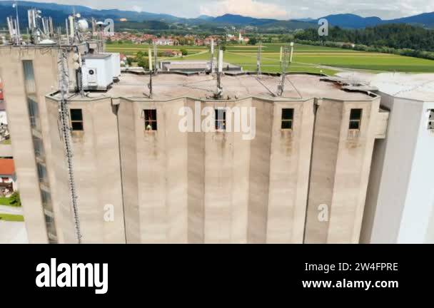 A huge building on one side of a village. A day is nice and sunny Stock ...