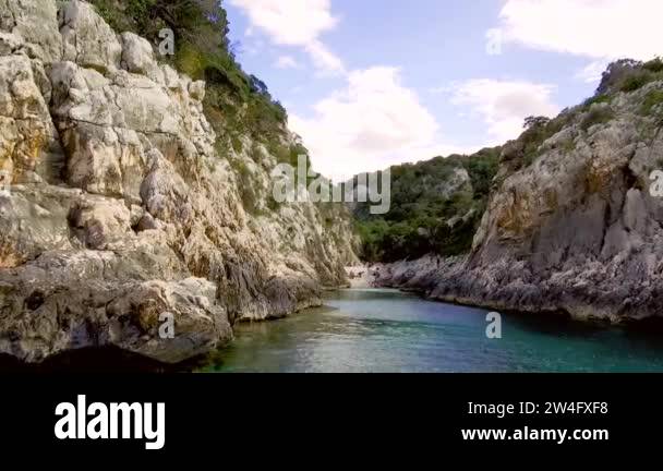 The narrow steep inlet of Portu Pedrosu cut into the limestone rock of ...