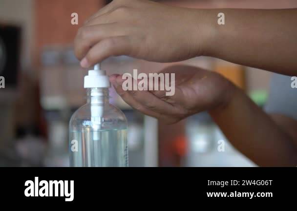 Male hands push the dispenser and squeeze out liquid soap. Hand ...