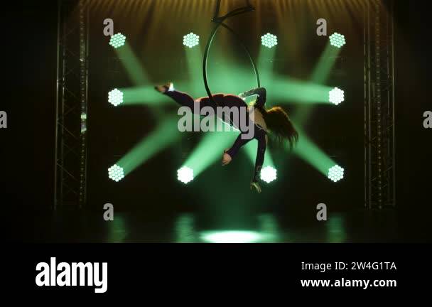 Female circus performer demonstrates her flexibility in an aerial ...