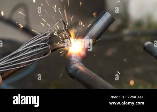Worker welds pipe gas welding. Closeup. sparks flying around flame ...