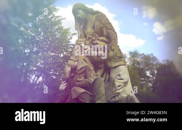 Figure of a praying angel. A very ancient stone statue. . Sad angel as ...