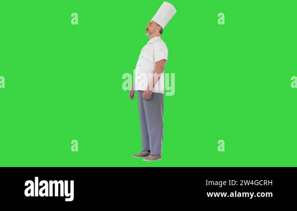 Smiling chef welcomes guests to his restaurant on a Green Screen ...