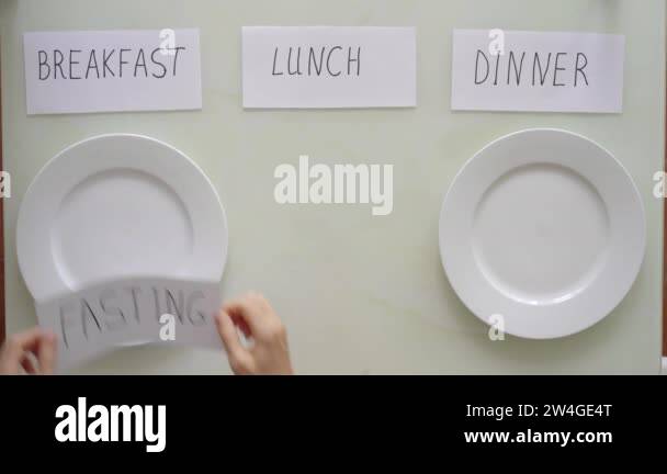 Hands of a woman put a plate with brown rice and vegetables under the ...