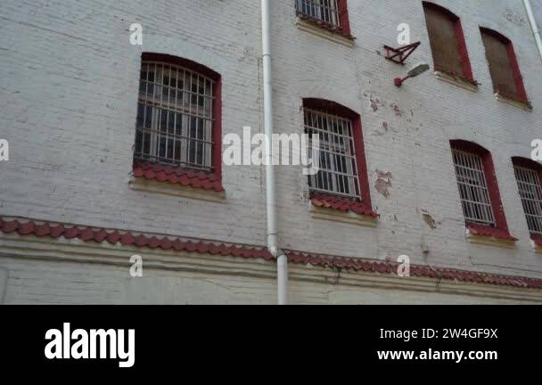 Coils of Barbed Wire on Top of a Fence. Jail Cells. Prison Interior ...