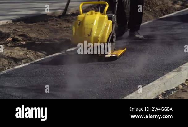 Men at work. Road construction. Bulk rubble. Worker and road equipment ...