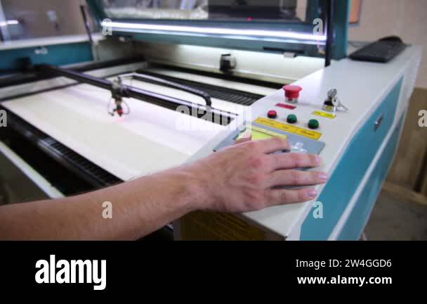 Employee presses keys on plotter control panel in typography Stock ...