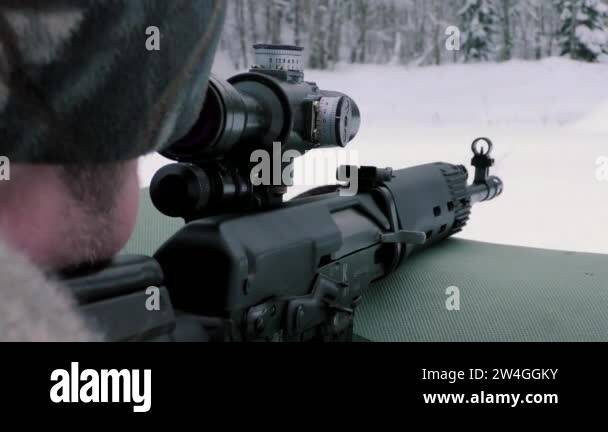 A sniper shoots a Tiger carbine in winter. Shooting at a target through ...