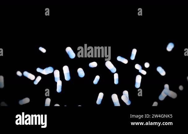 Flying many medical capsules on black background. Medicine and ...