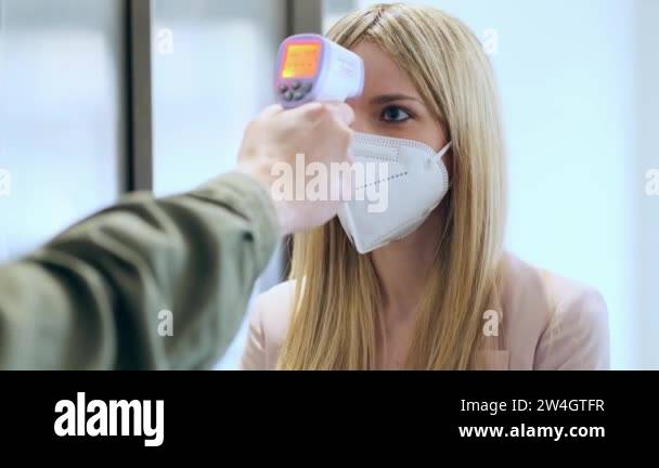 Video of oung business person passing temperature control at the office ...