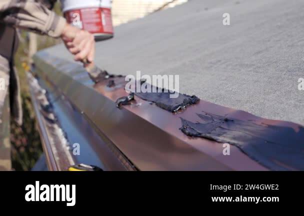 Smearing of seams with bituminous mastic. Preparation for laying a soft ...