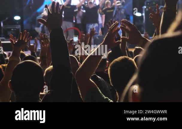 Crowd of Fans at a Rock Concert Raise their Hands Up. Slow Motion Stock ...