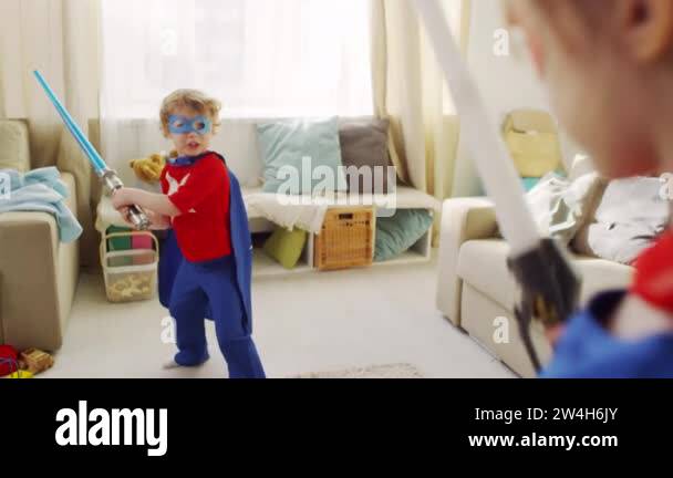 Over-the-shoulder medium shot of kids in superhero costumes with eye ...