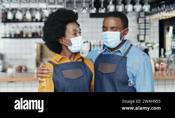 Portrait of African American joyful couple of bartenders in medical ...