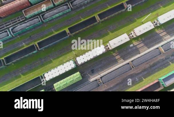 A freight train moves across a railway station frame with rotation from ...