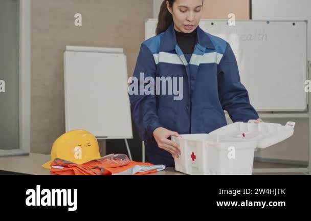 Tilt-up medium slowmo of young female factory supervisor giving lecture ...