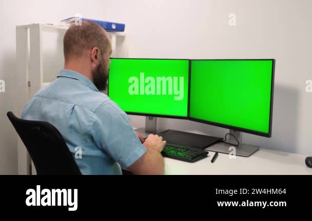 freelancer Working on a Computer, Two Monitor Screens Show Chroma Key ...