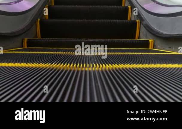 Low angle looped perspective view of modern escalator stairs. Automated ...