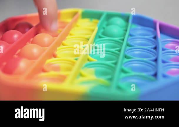 clicks on the toy Pop It Fidget. side view Stock Video Footage - Alamy