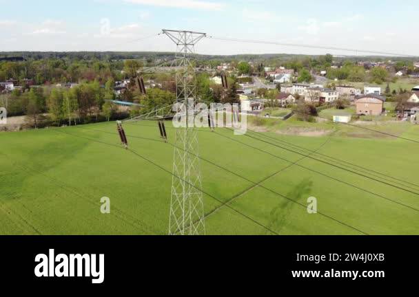 Power pylons and high voltage lines in an agricultural landscape. High ...
