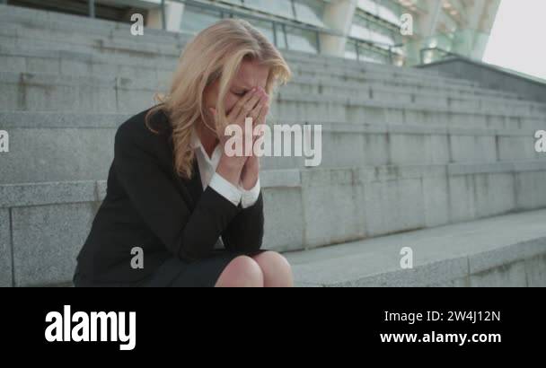 Upset businesslady crying on stairs alone depressed by failure at work ...