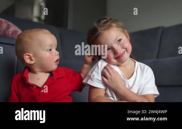 Beautiful little boy and girl clap their hands and smile. Kid kissing ...